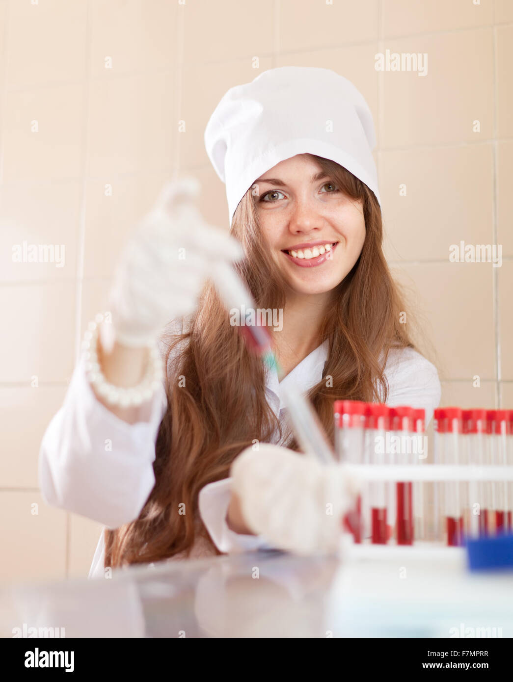 Friendly nurse works with blood sample in medical laboratory Stock ...
