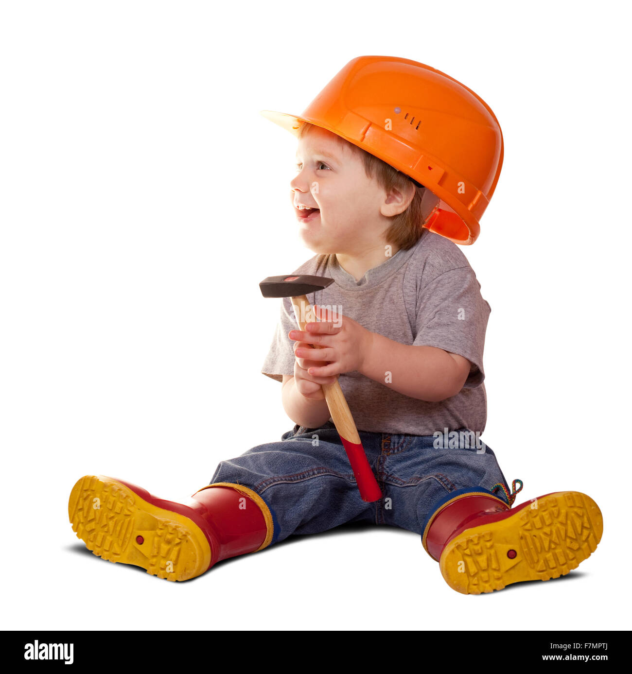 Toddler in hardhat with hammer. Isolated over white background with ...