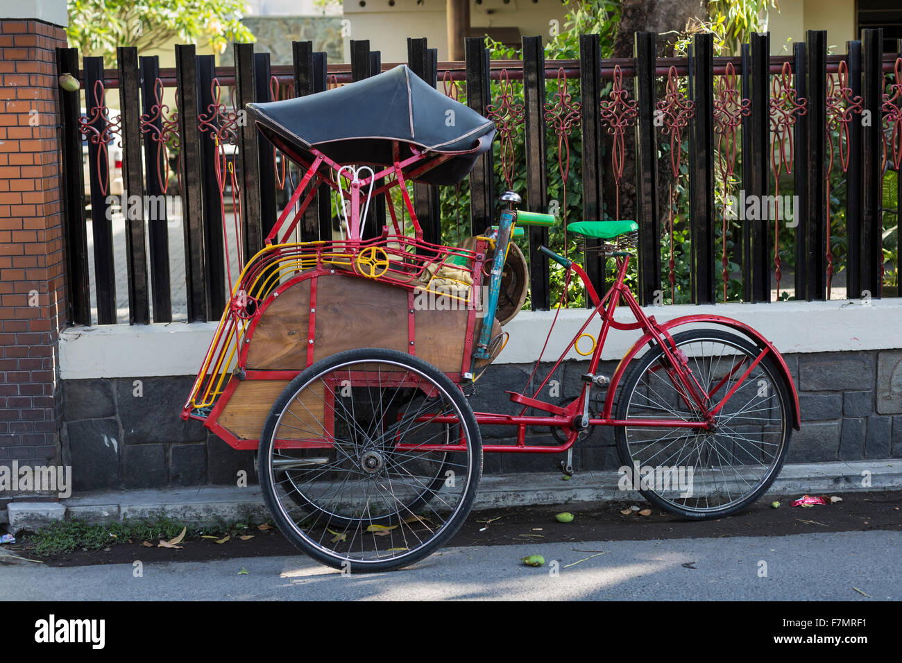 Colorful becaks on a street of Yogjakarta, Indonesia Stock Photo - Alamy