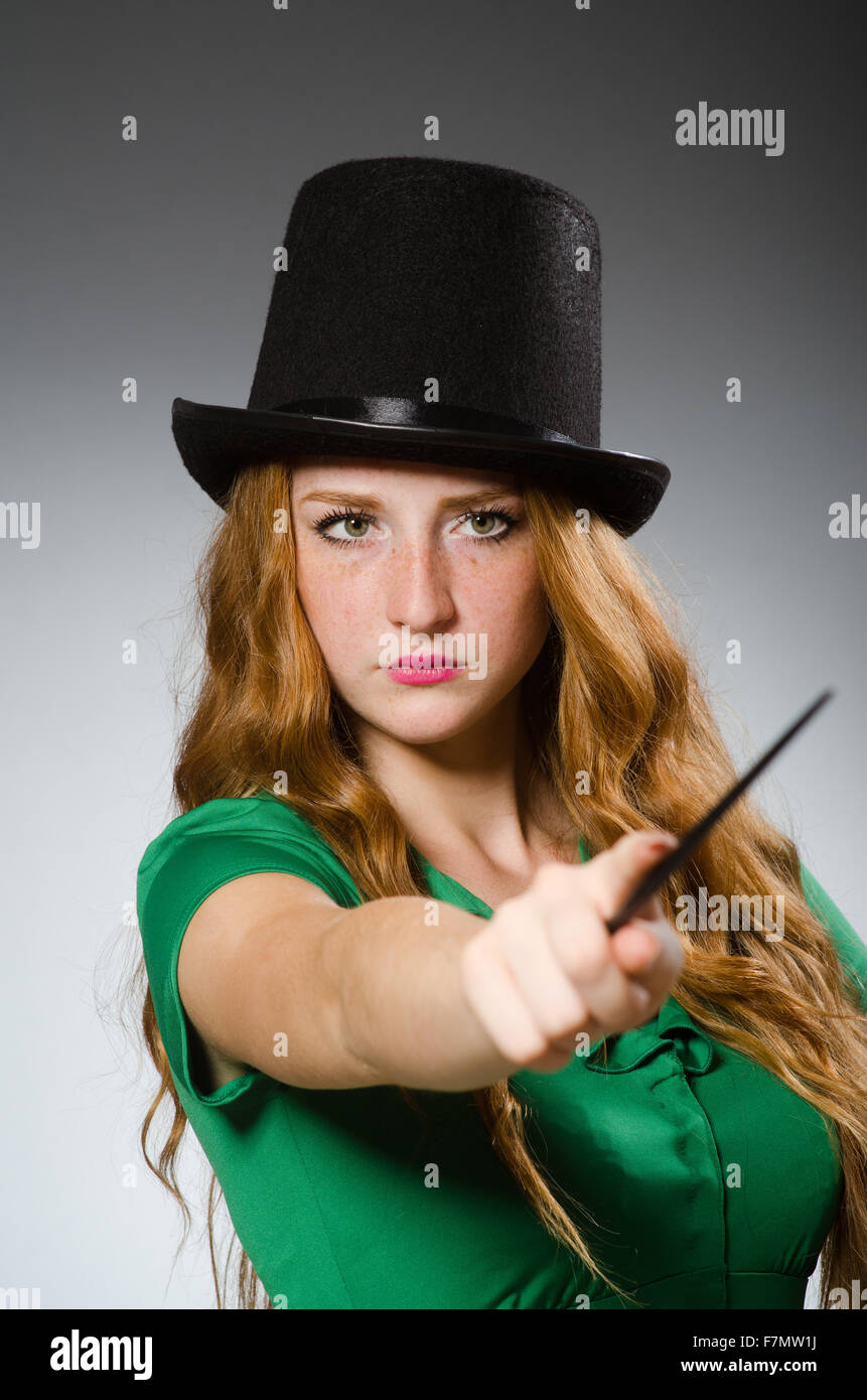 Woman magician wearing green dress Stock Photo - Alamy