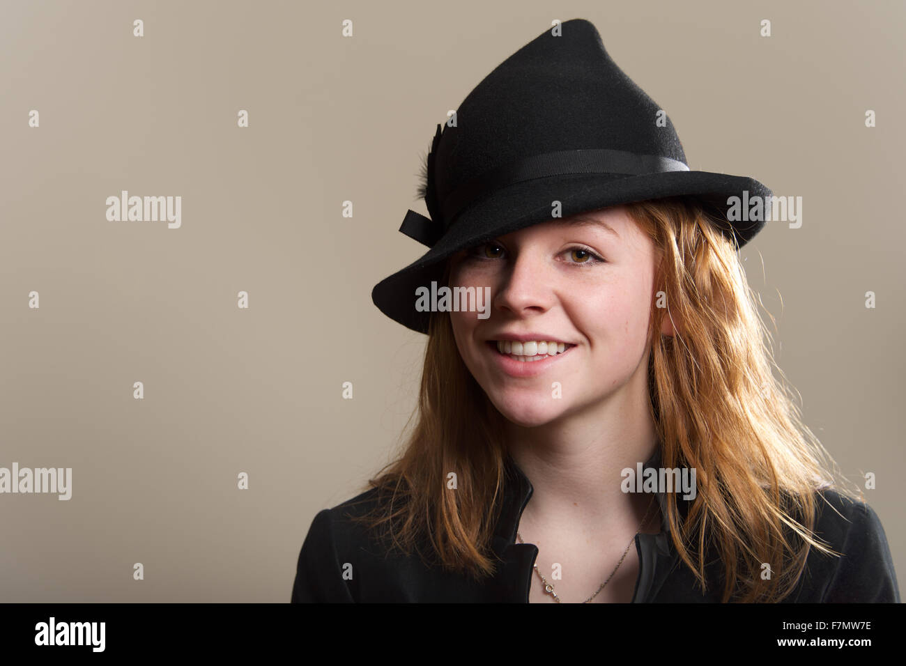 Redhead smiling in black hat and jacket Stock Photo - Alamy