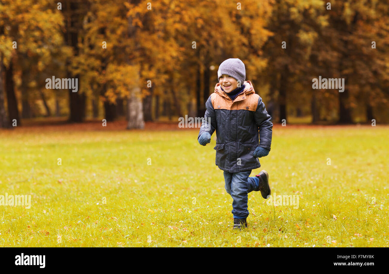 happy little boy running on autumn park field Stock Photo - Alamy