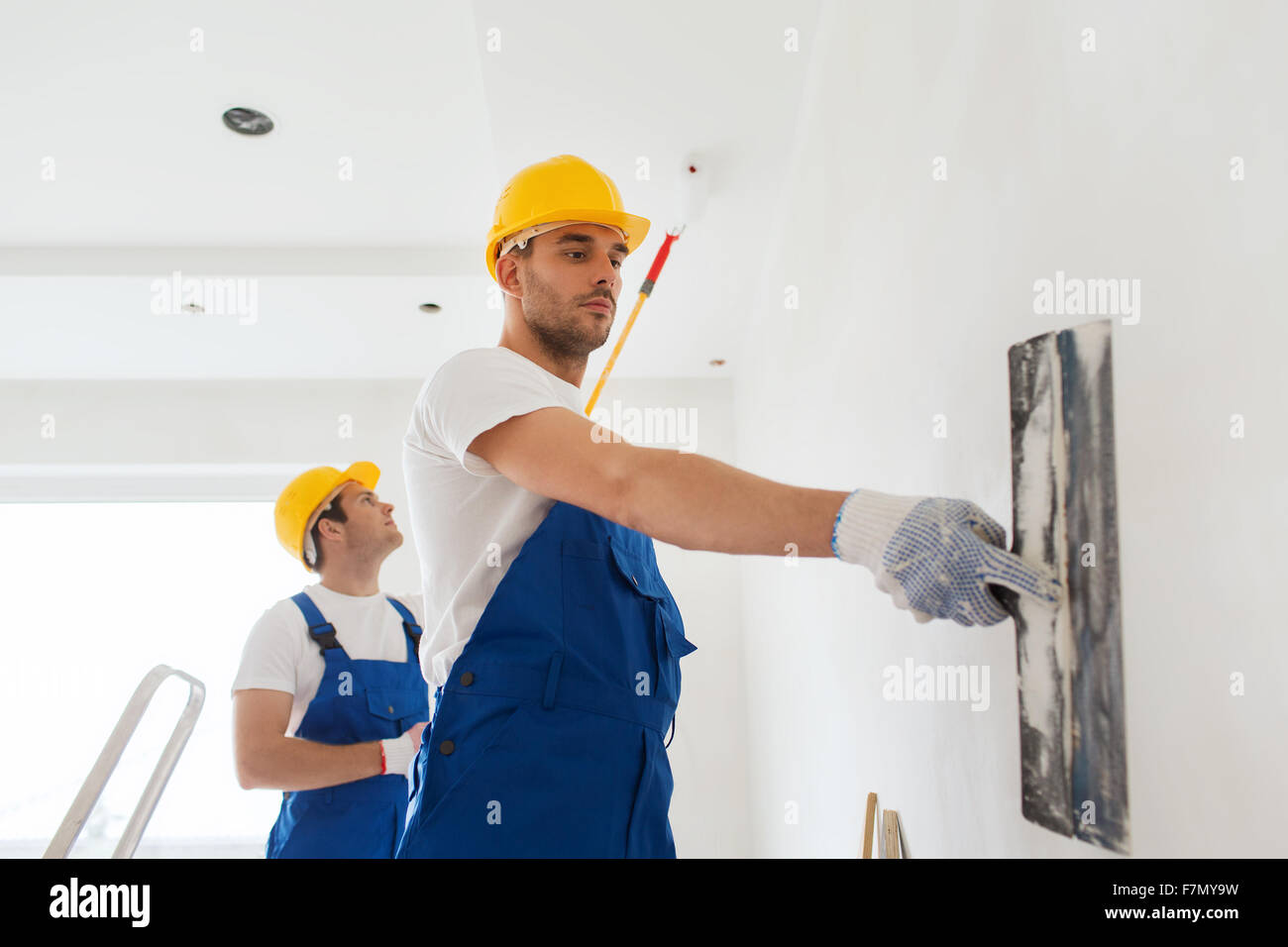 group of builders with tools indoors Stock Photo - Alamy
