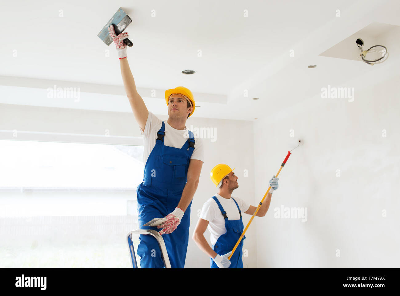 group of builders with tools indoors Stock Photo - Alamy