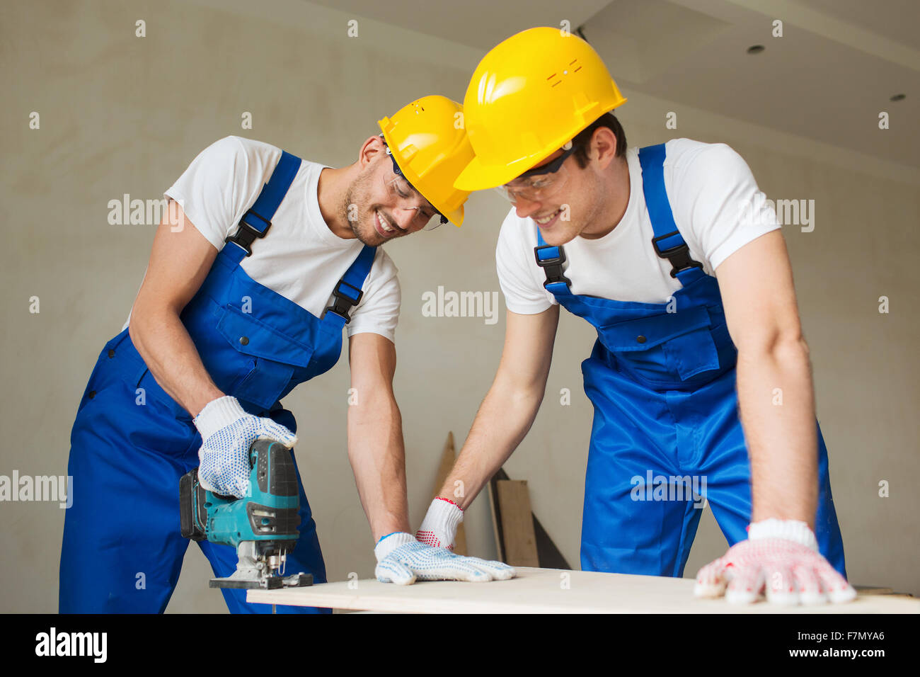group of builders with tools indoors Stock Photo - Alamy