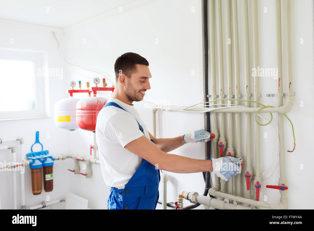 builder or plumber working indoors Stock Photo - Alamy