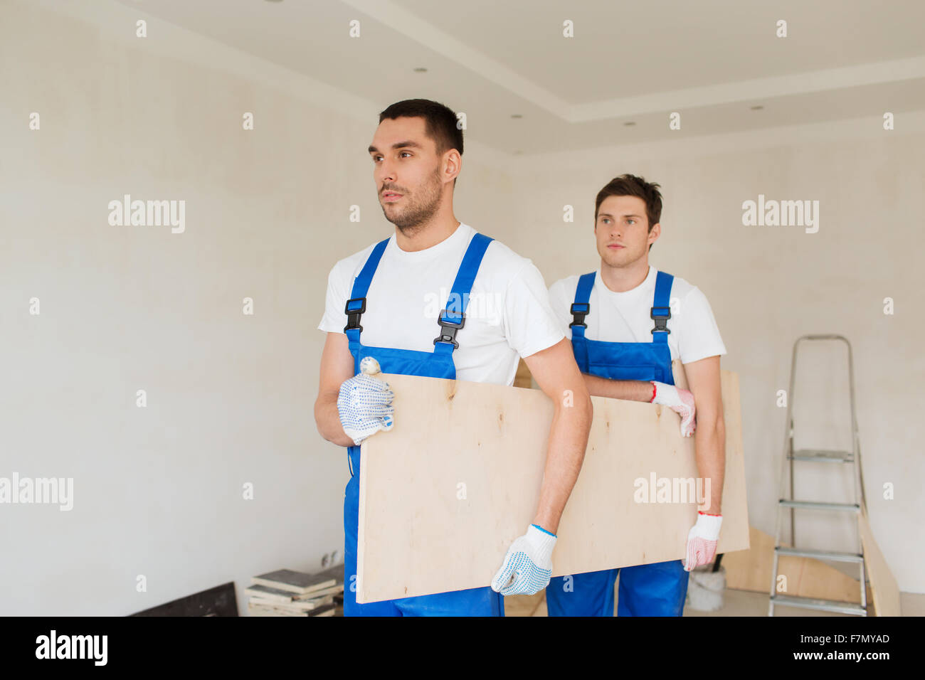 group of builders with wooden boards Stock Photo - Alamy