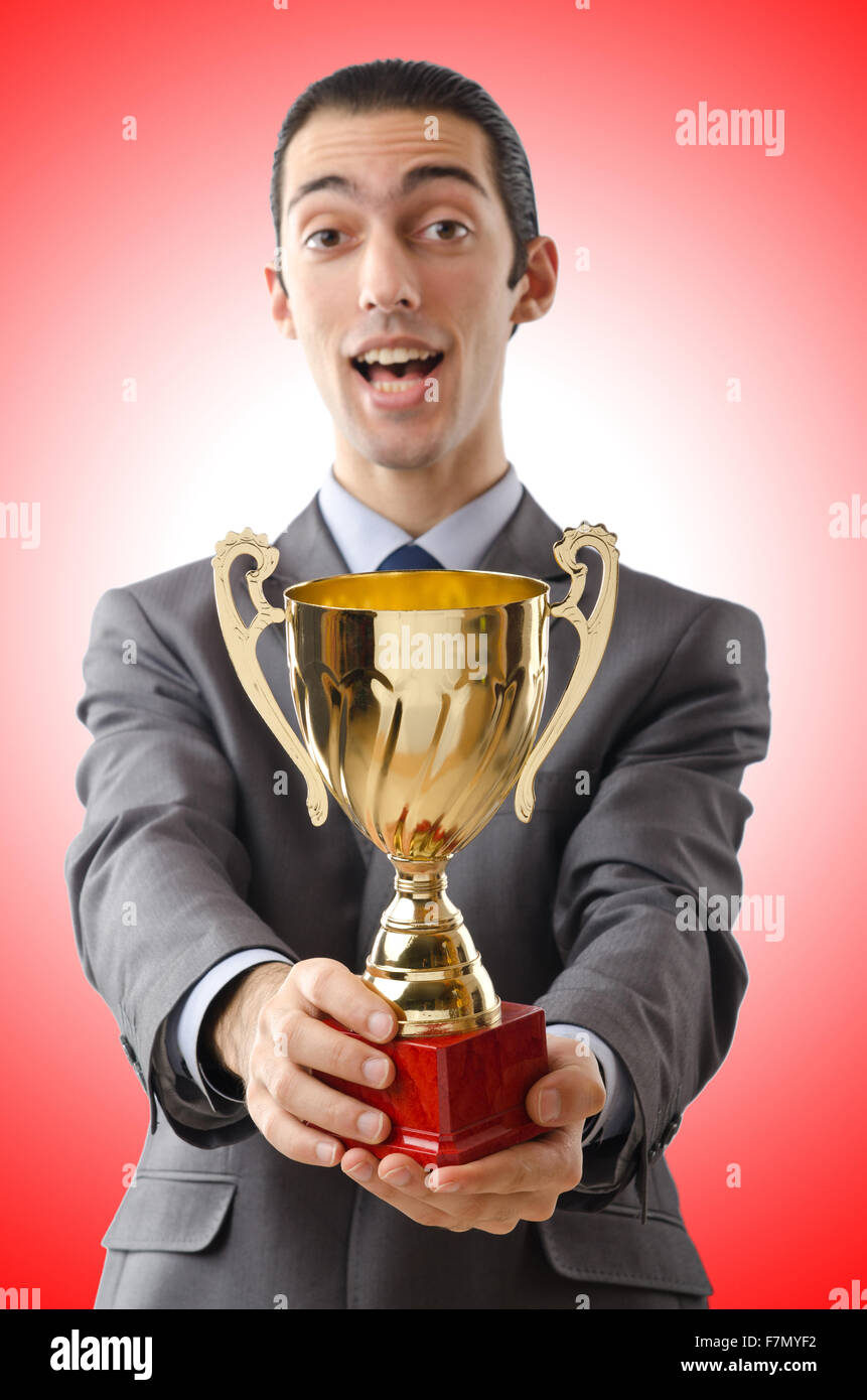 Man being awarded with golden cup Stock Photo - Alamy