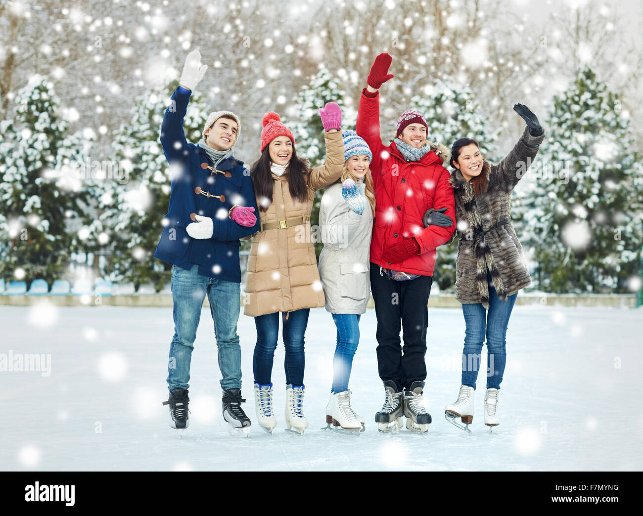 happy friends ice skating on rink outdoors Stock Photo - Alamy