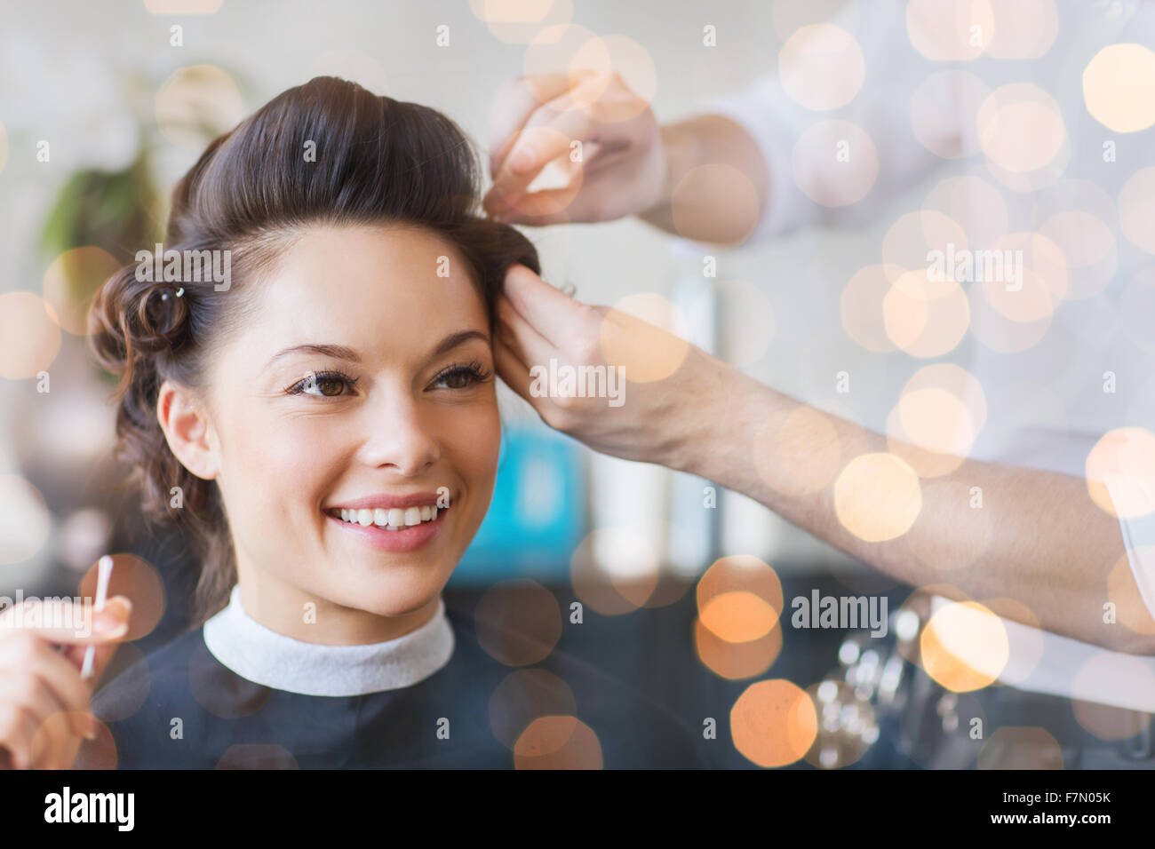 happy woman with stylist making hairdo at salon Stock Photo - Alamy