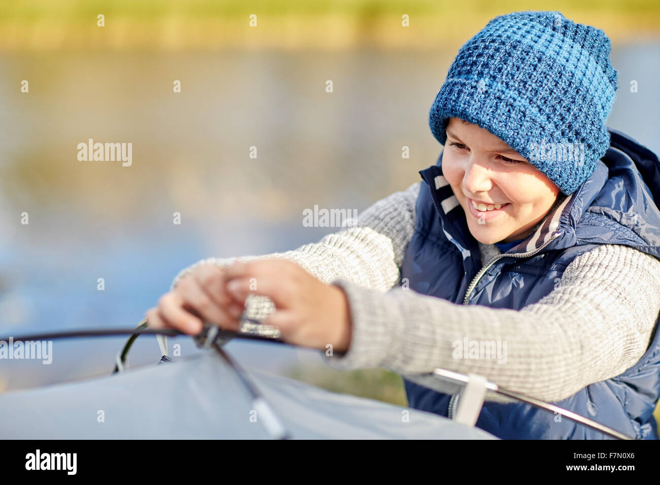 happy boy setting up tent outdoors Stock Photo - Alamy