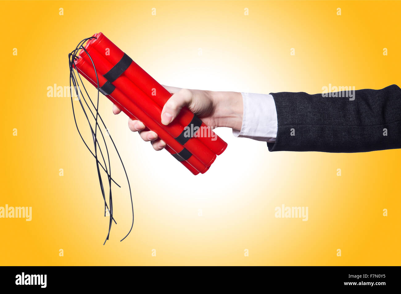 Hand holding bars of dynamite on white Stock Photo - Alamy