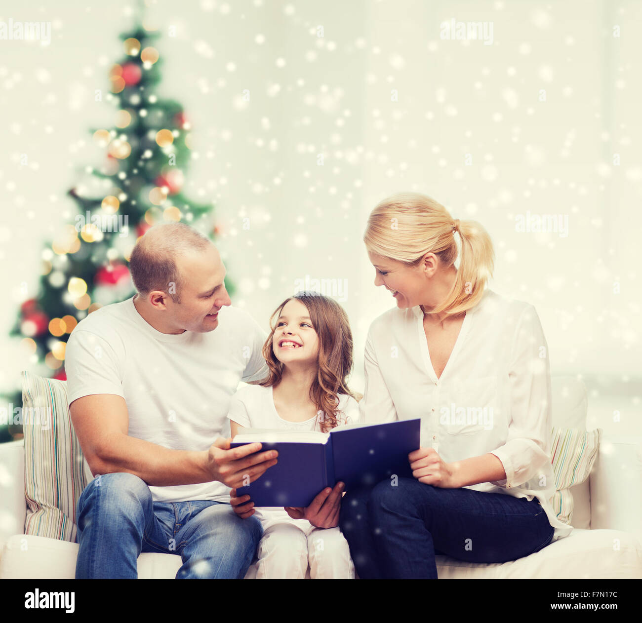 happy family with book at home Stock Photo - Alamy