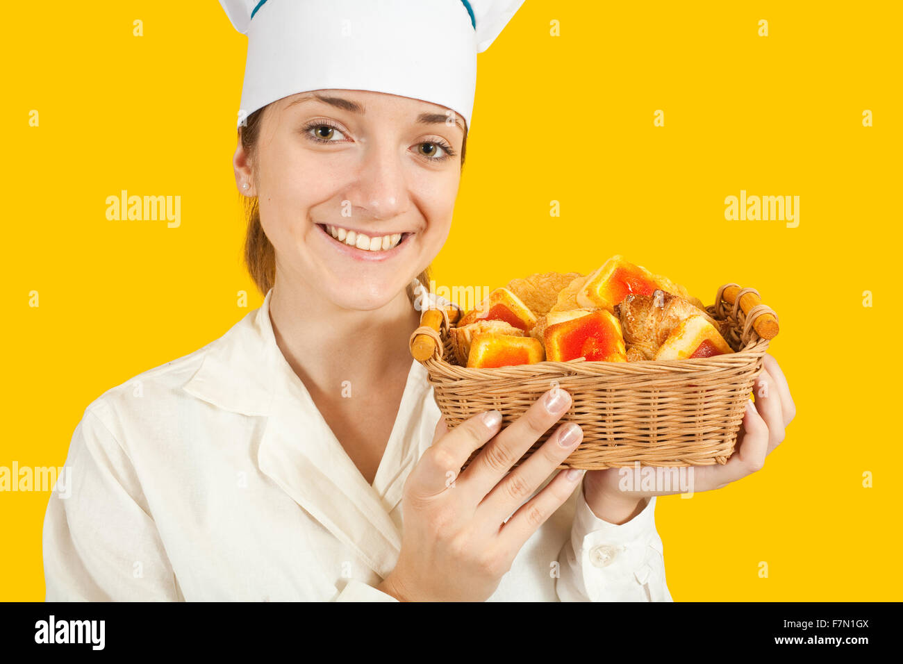 female cook with pastry over yellow background Stock Photo - Alamy