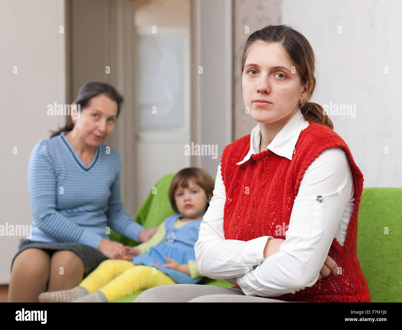 Conflict between generations. Sad young woman against grandmother and ...