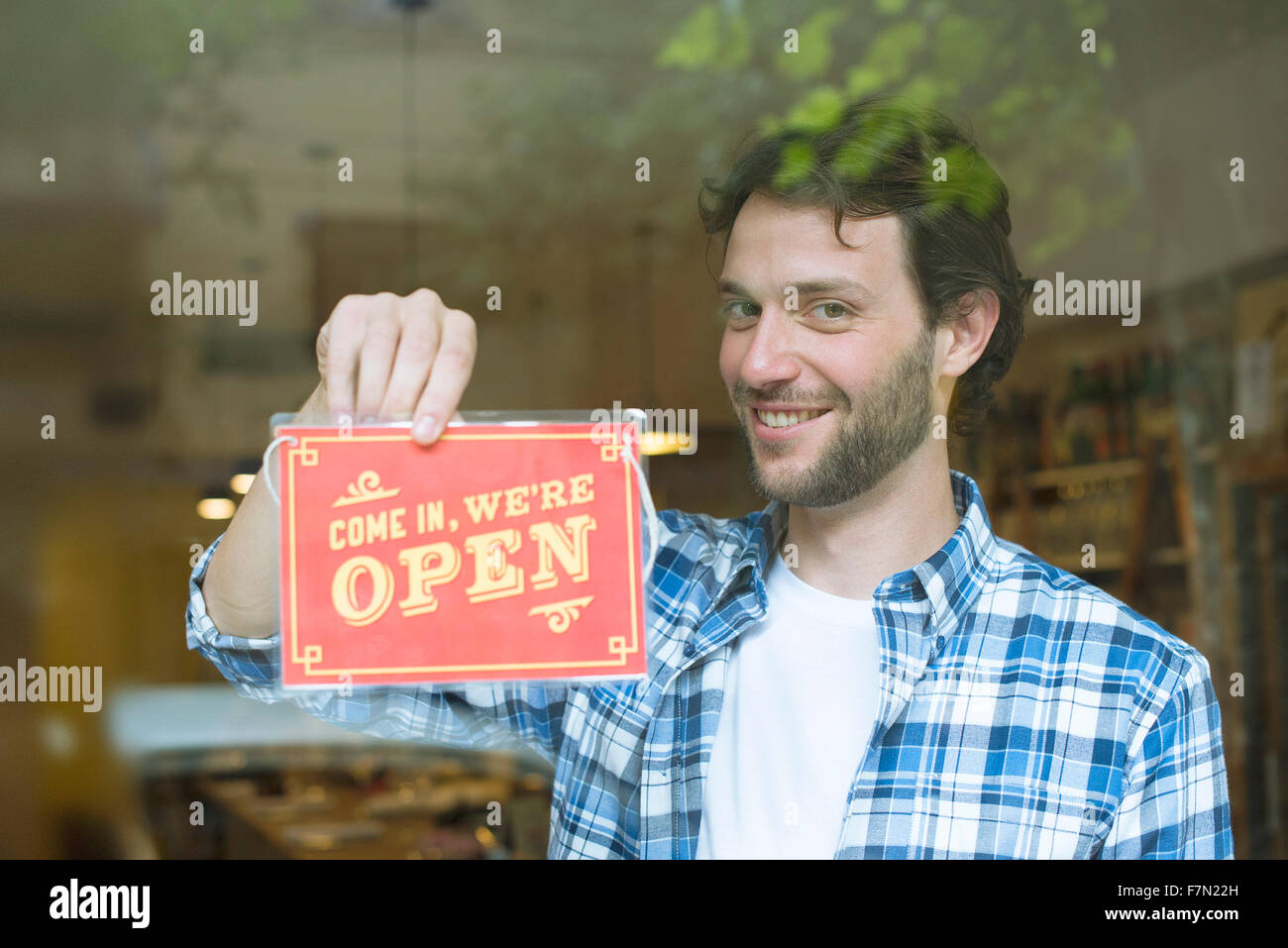 Businessman opening shop for business Stock Photo - Alamy
