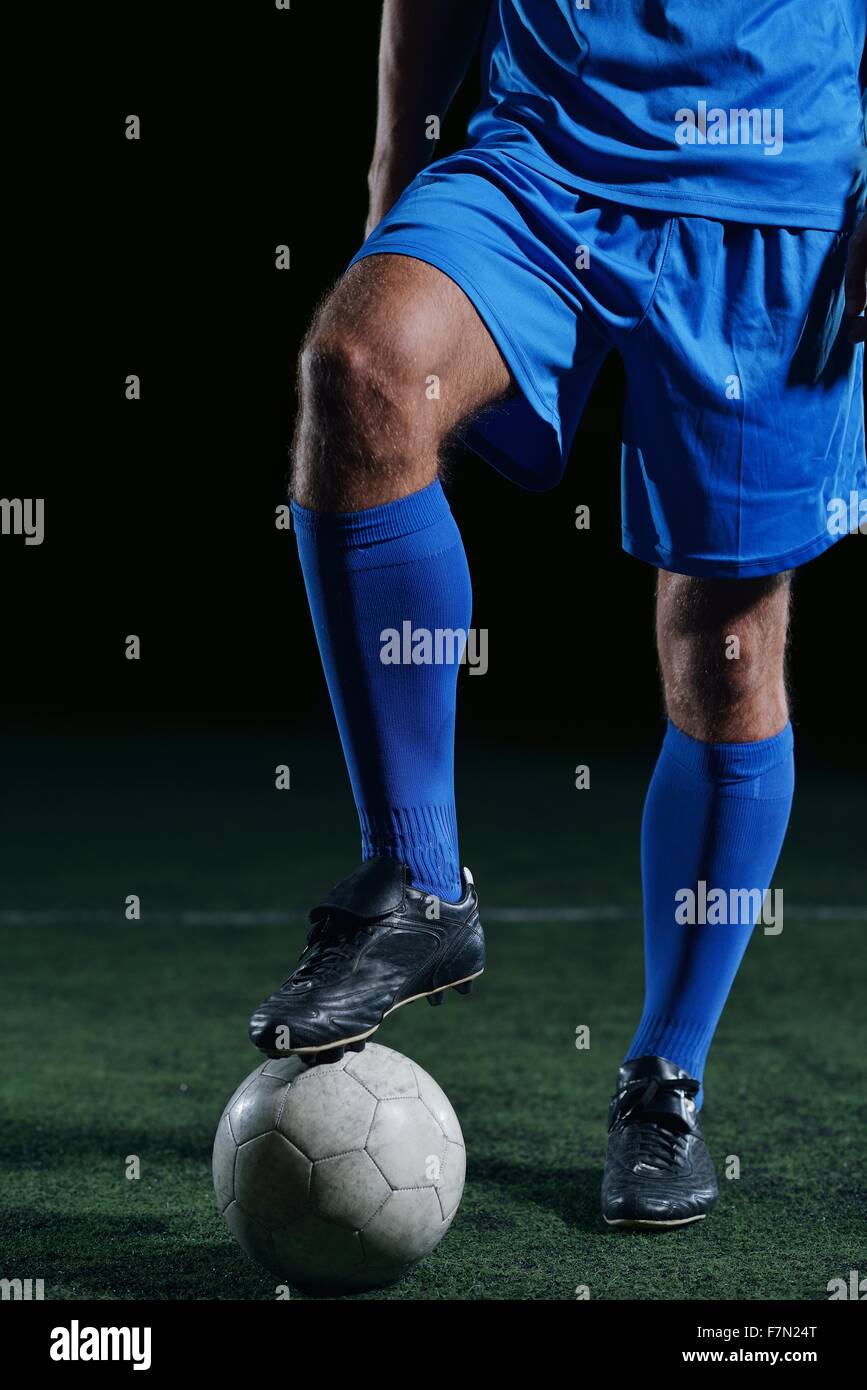 soccer player doing kick with ball on football stadium field isolated ...