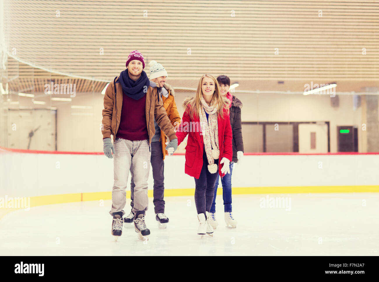 happy friends on skating rink Stock Photo - Alamy