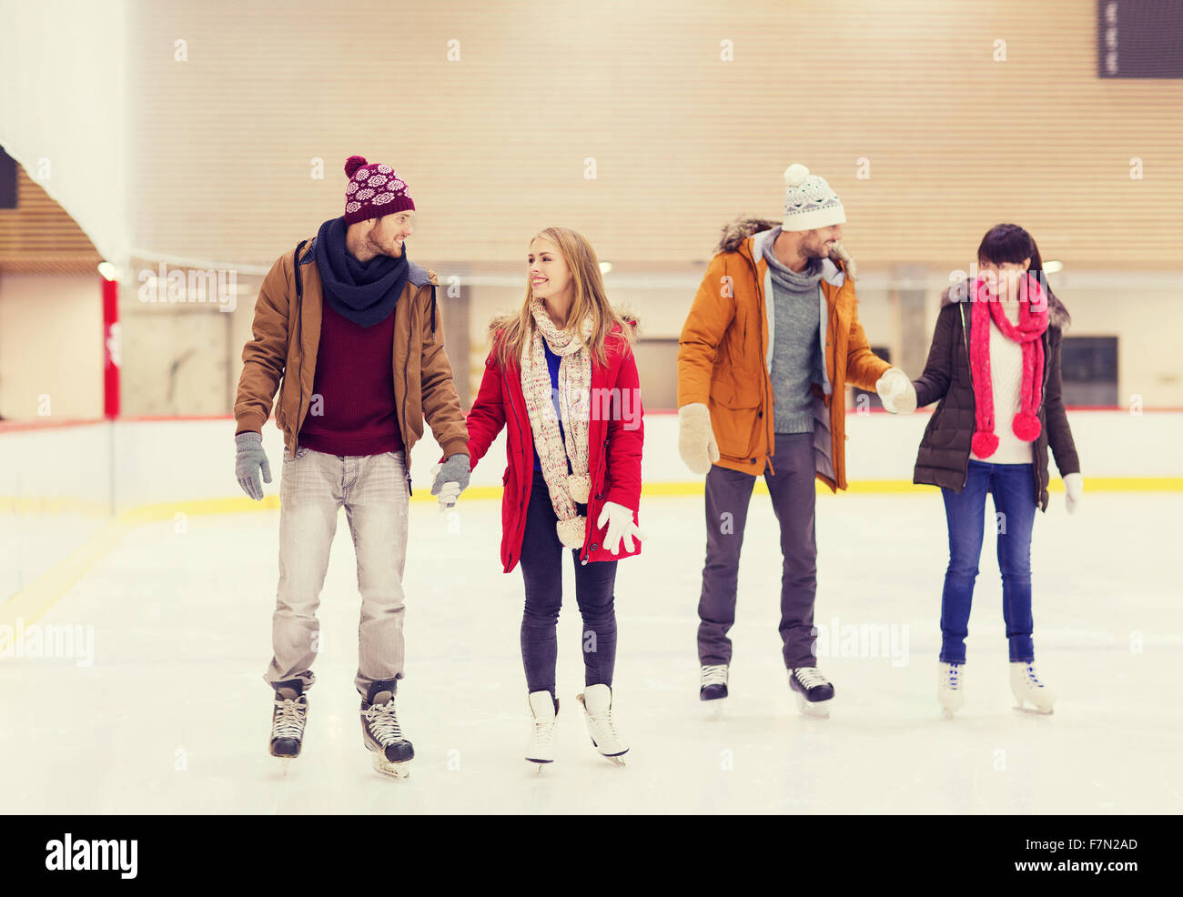 happy friends on skating rink Stock Photo - Alamy