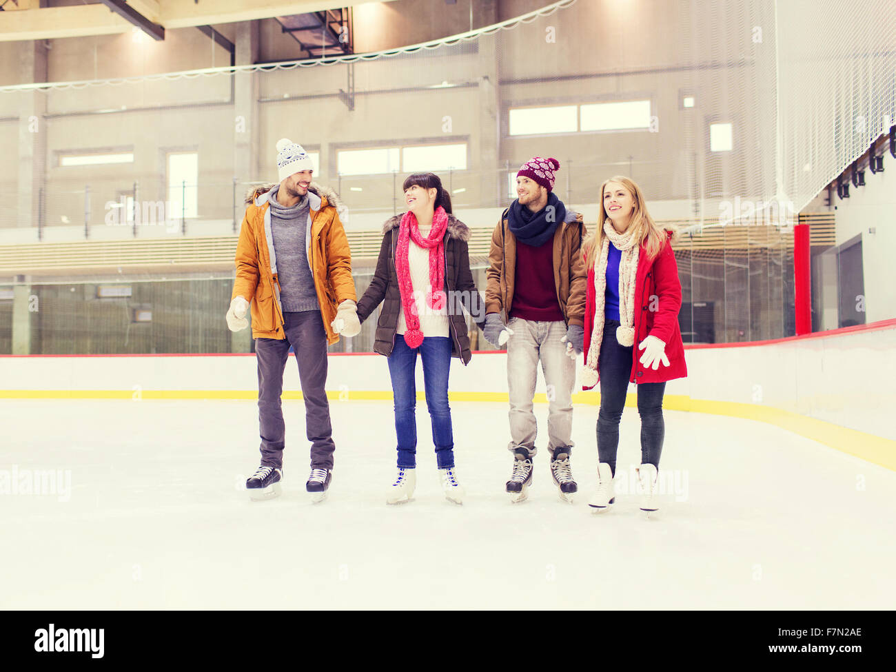 happy friends on skating rink Stock Photo - Alamy
