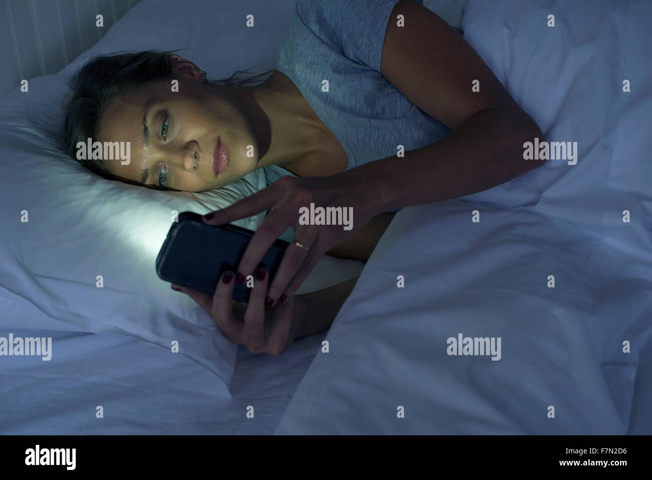 Women using mobile phones in bed hi-res stock photography and images ...