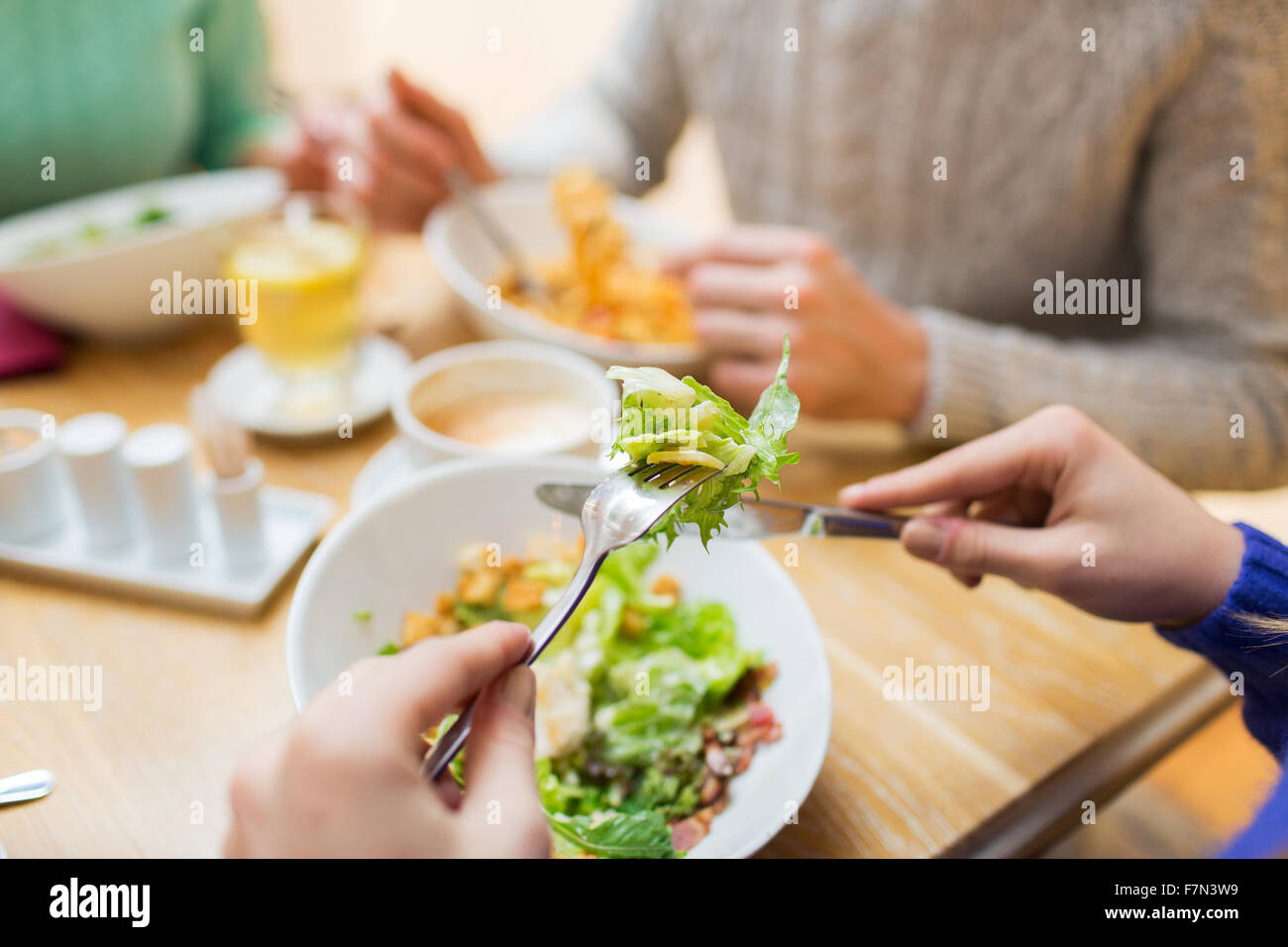 close up friends having dinner at restaurant Stock Photo - Alamy