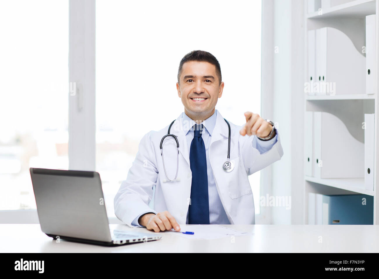 smiling doctor pointing finger at you in office Stock Photo - Alamy