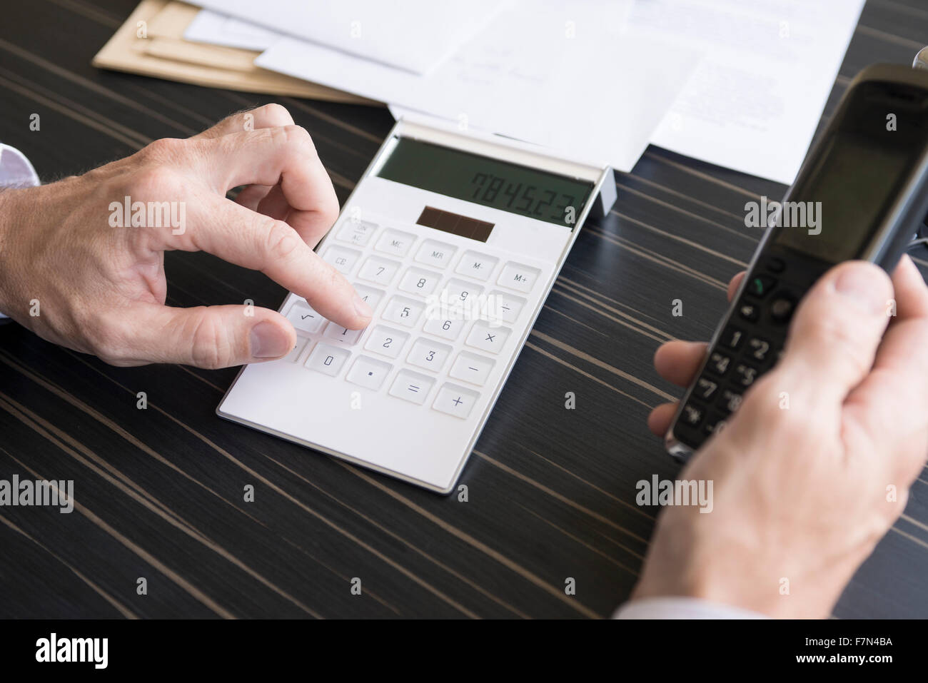 Businessmen hands using smartphone calculator hi-res stock photography ...