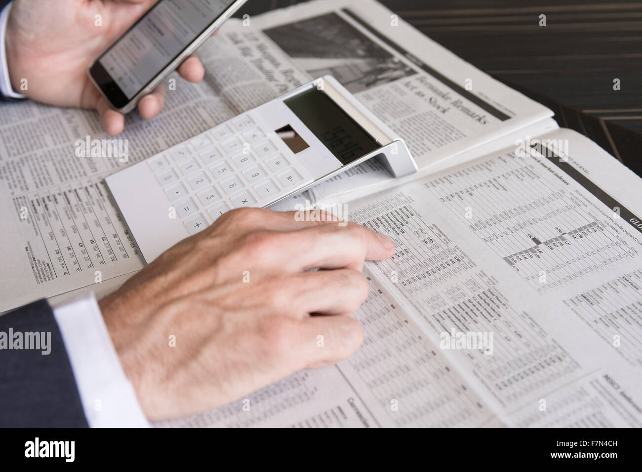 Checking stock market performance using smartphone and newspaper Stock ...