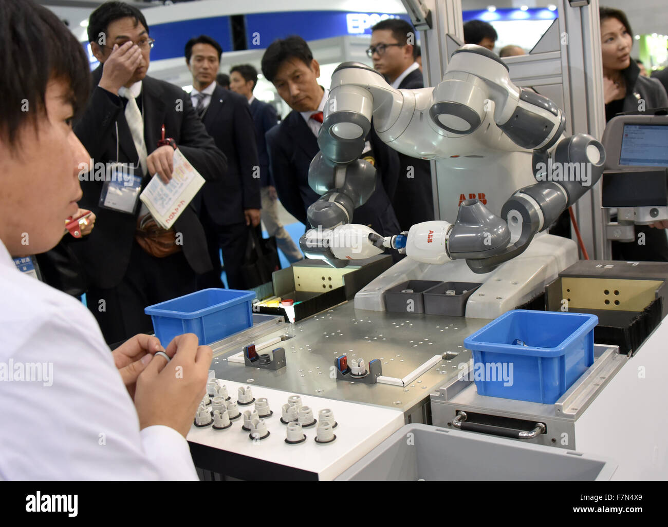Tokyo, Japan. 2nd Dec, 2015. An assembling robot works with a human ...