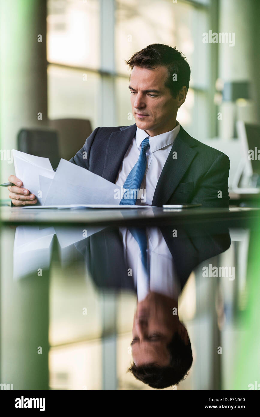Focused businessman reviewing documents hi-res stock photography and ...