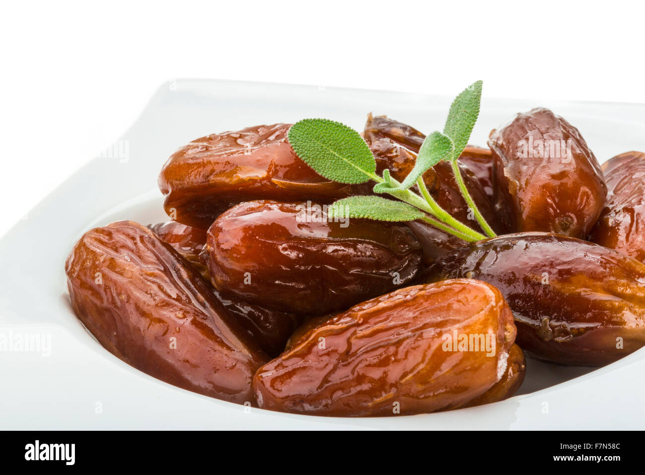 Dates with leaf on the plate Stock Photo - Alamy