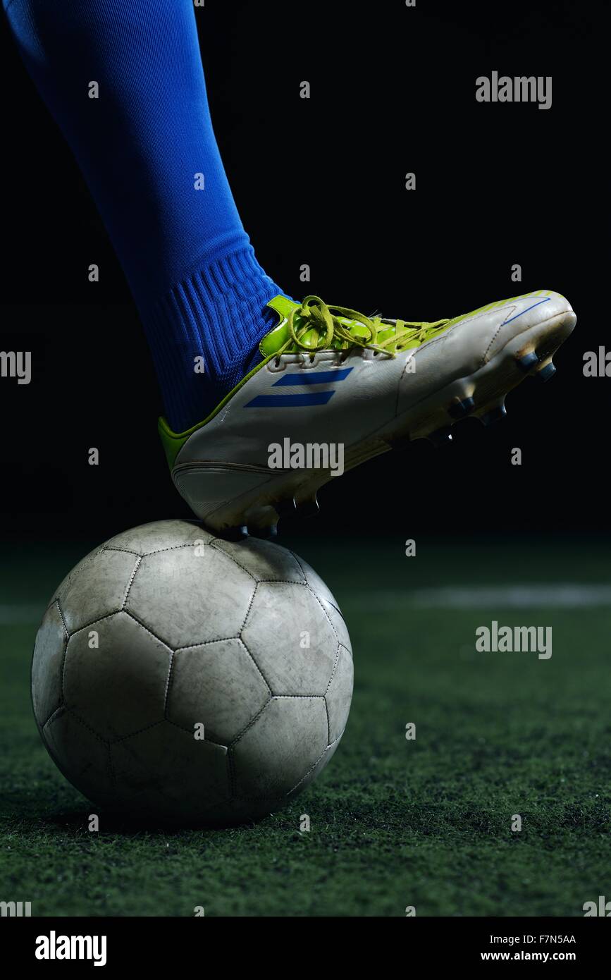 soccer player doing kick with ball on football stadium field isolated ...