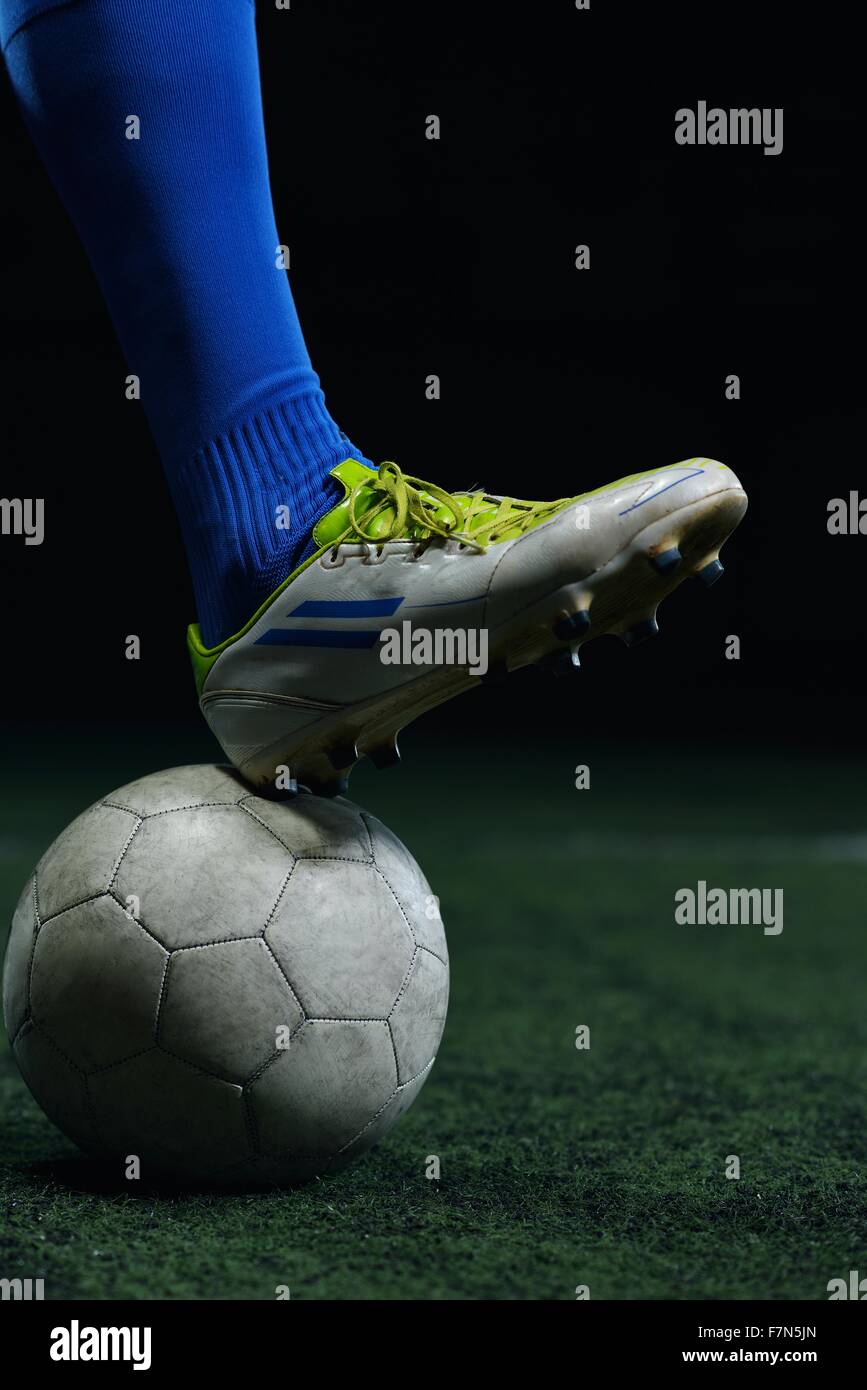 soccer player doing kick with ball on football stadium field isolated ...