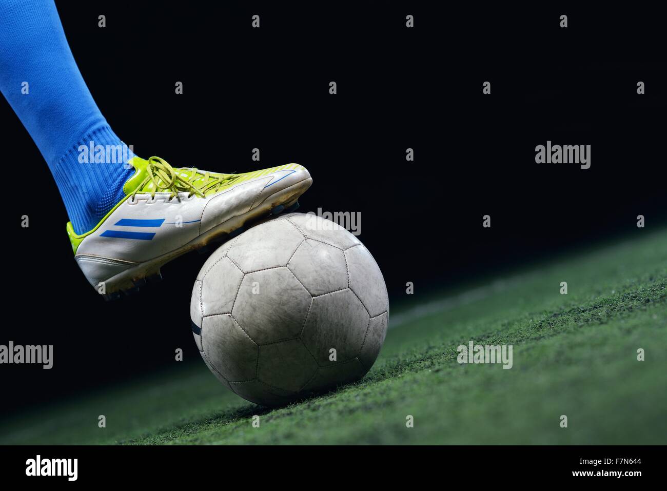 soccer player doing kick with ball on football stadium field isolated ...
