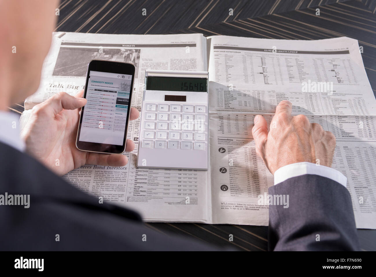 Using smartphone and newspaper to monitor stock performance Stock Photo ...