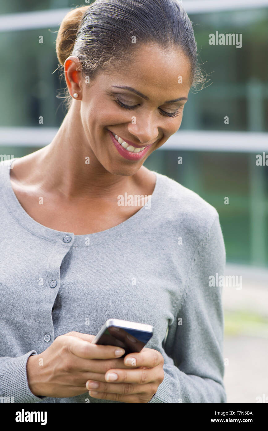 Woman text messaging with smartphone Stock Photo - Alamy