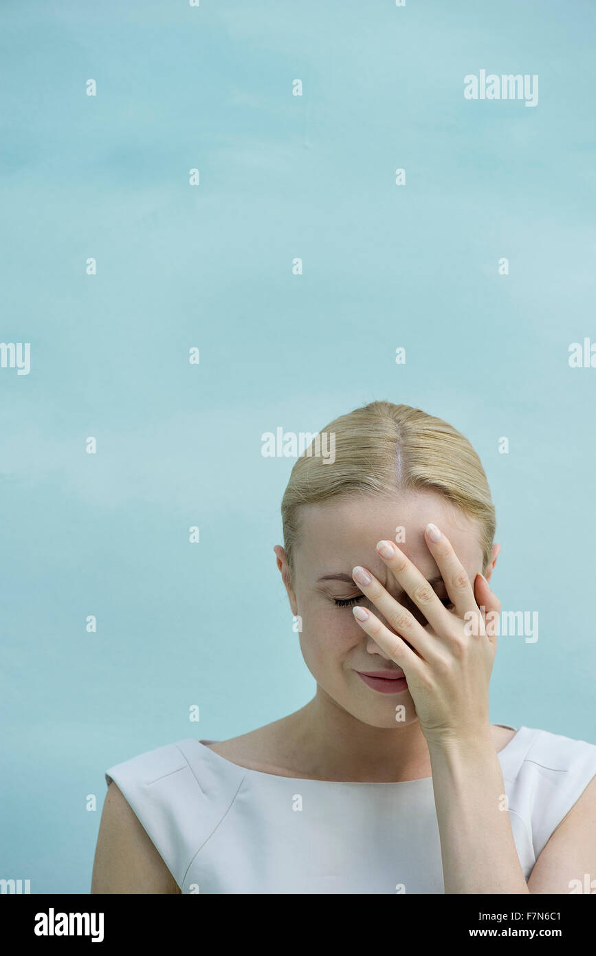 Woman covering face with hand Stock Photo - Alamy