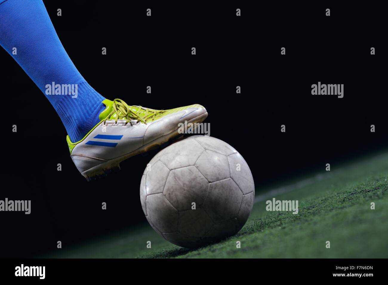 soccer player doing kick with ball on football stadium field isolated ...