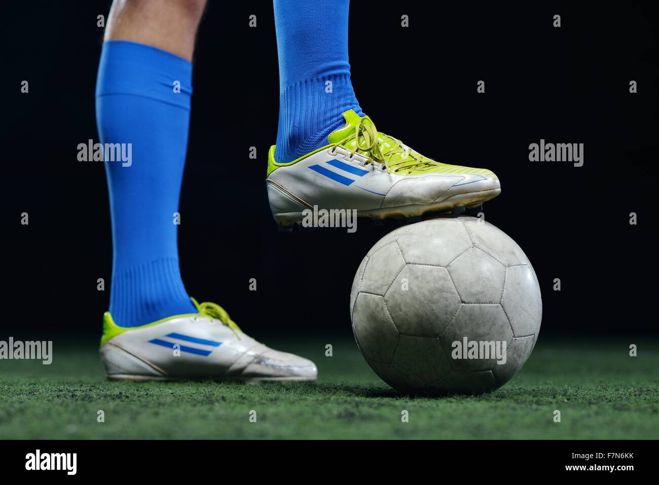 soccer player doing kick with ball on football stadium field isolated ...