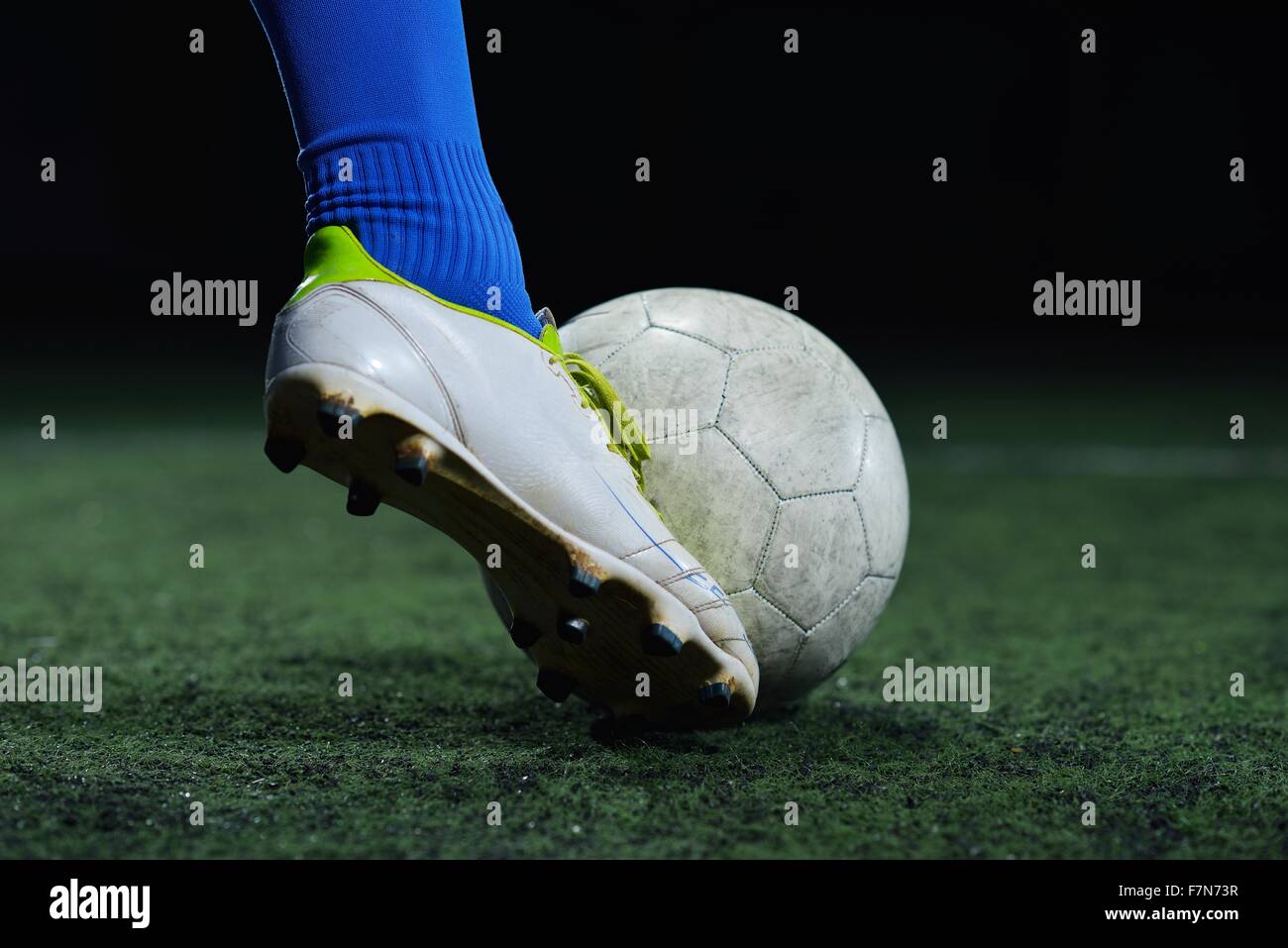 soccer player doing kick with ball on football stadium field isolated ...