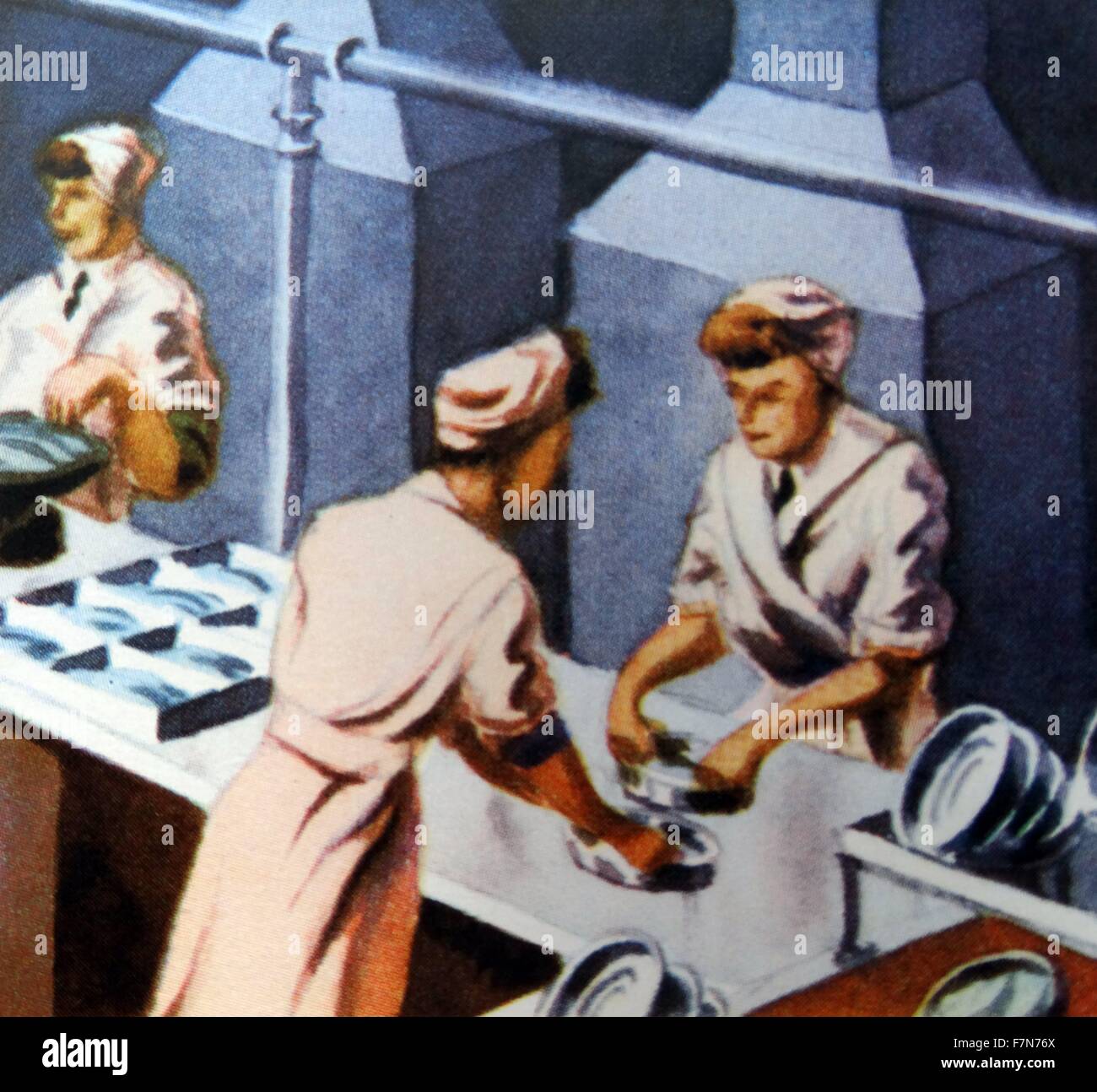 Two women work on a production line at a fish canning factory, England ...