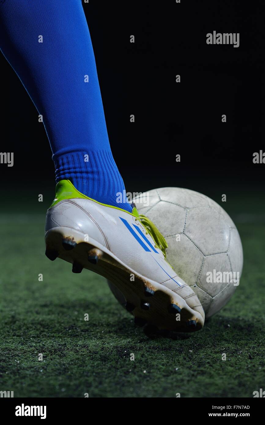 soccer player doing kick with ball on football stadium field isolated ...