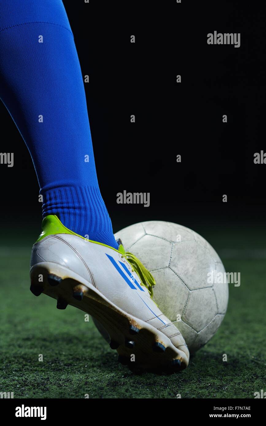 soccer player doing kick with ball on football stadium field isolated ...