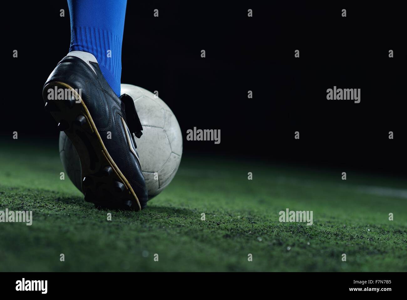 soccer player doing kick with ball on football stadium field isolated ...