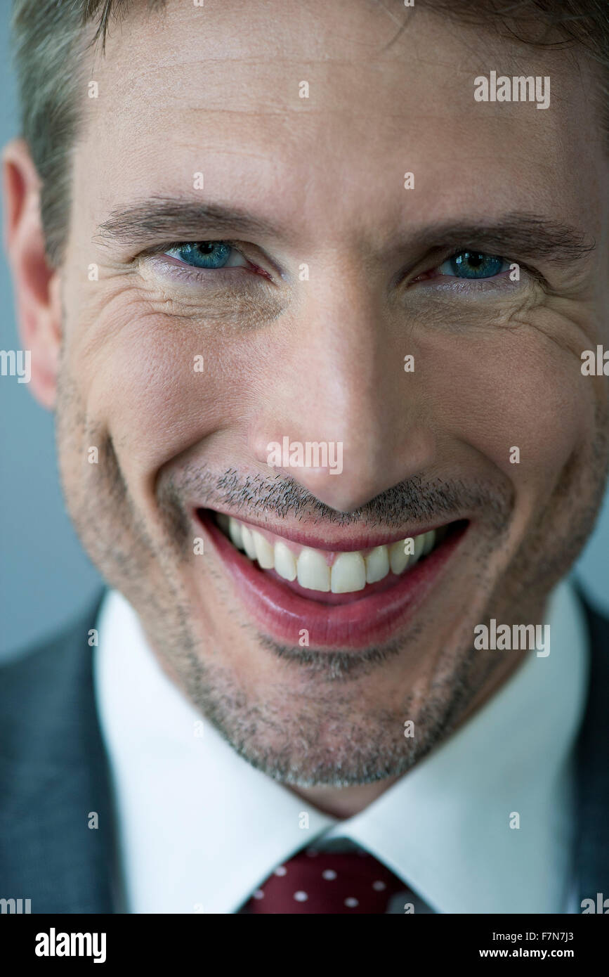 Businessman smiling cheerfully, portrait Stock Photo - Alamy