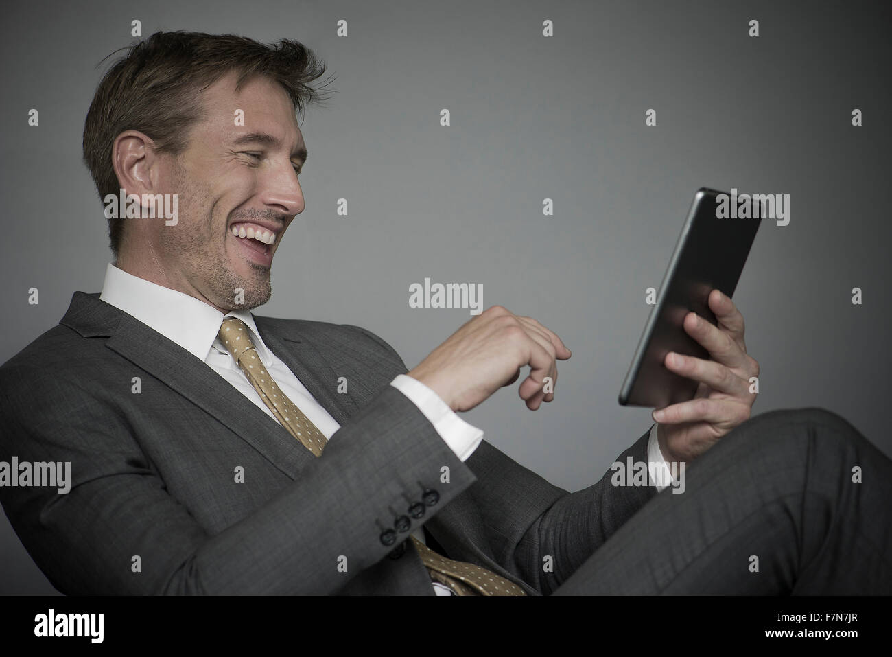 Person looking at ipad and laughing hi-res stock photography and images ...