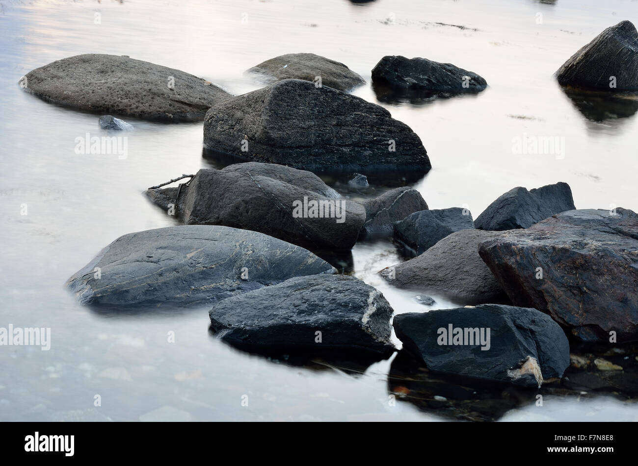 Beautiful stones in misty arctic circle fjord water Stock Photo - Alamy