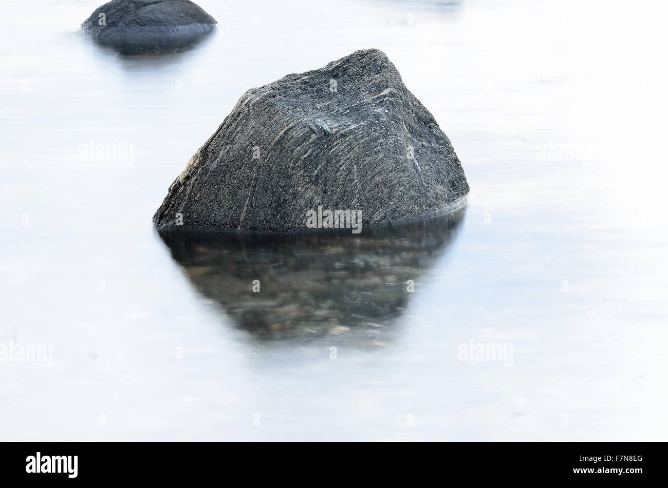 Beautiful stones in misty arctic circle fjord water Stock Photo - Alamy