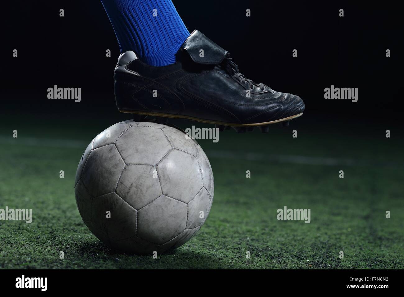 soccer player doing kick with ball on football stadium field isolated ...